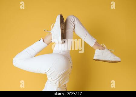 Inverted womens legs sneakers fashion studio street style Stock Photo ...