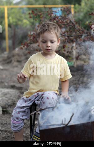 Boy making bonfire at the backyard Stock Photo - Alamy