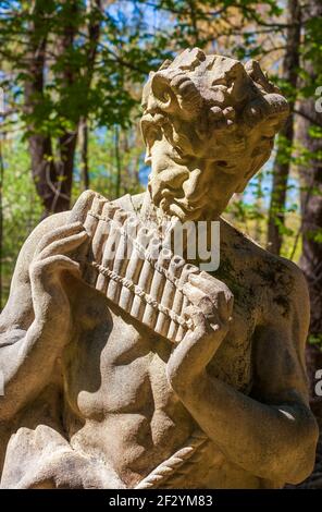 Stone garden statue of Pan playing his pipes Stock Photo - Alamy