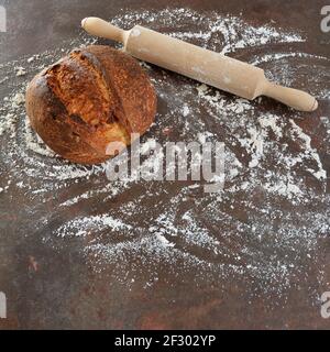 Fresh Rustic Bread Loaf With Rolling Pin On Dark Kitchen Table Stock ...