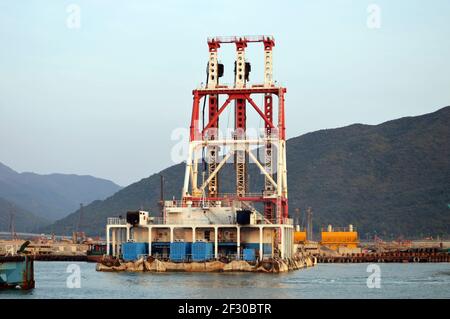 Deep cement mixing (DCM) rigs being used for land reclamation at Tung ...
