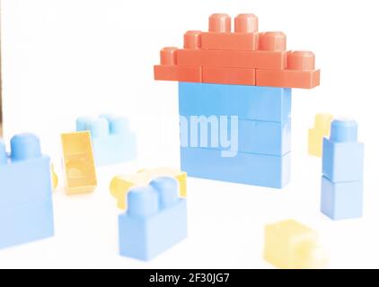 Closeup of colorful interlocking plastic brick toys and a pink copy ...