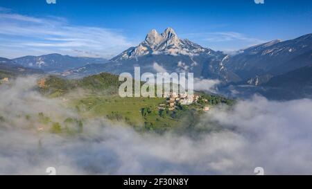 Aerial view of Pedraforca and the village of Maçaners over a sea of ...