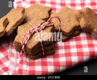 Star shaped baked gingerbread cookies sprinkled with powdered sugar on ...