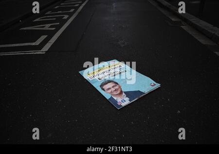 Mainz, Germany. 14th Mar, 2021. A voter casts his vote at a polling ...