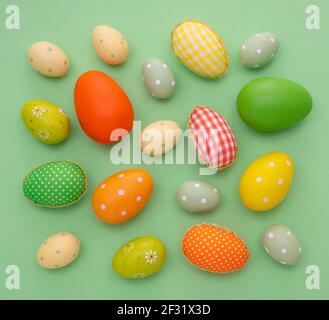 Easter eggs collection pastel colors on green background, top view ...