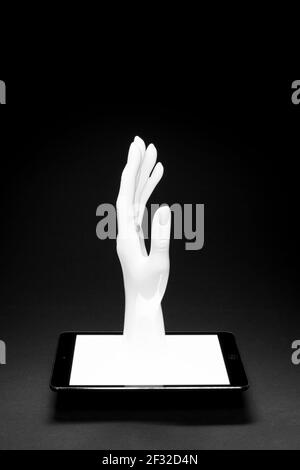 hand coming out of a computer monitor as for grabbing something ...