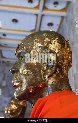 Gold-leaf covered statue of the monks that founded Wat Chalong, a 19th ...
