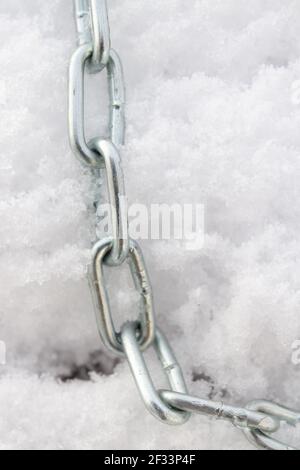 A metal chain lies on the snow in winter Stock Photo - Alamy