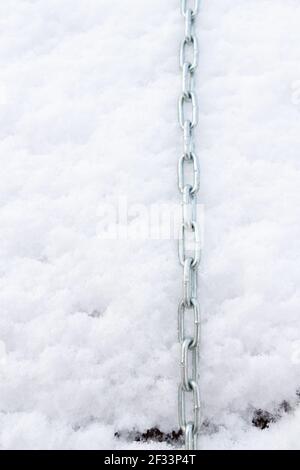 A metal chain lies on the snow in winter Stock Photo - Alamy