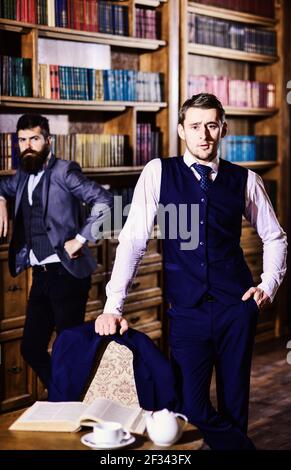 Men in suit, detectives spend leisure in library. Private investigator ...
