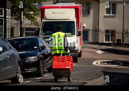 A Ocado delivery driver after dropping off food shopping outside a ...