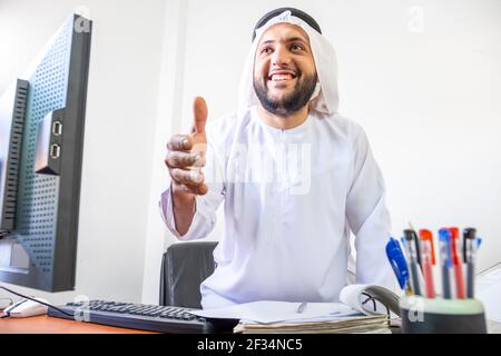 Arabic muslim manager standing to weclome his guest Stock Photo - Alamy