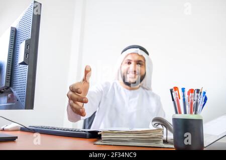 Arabic muslim manager standing to weclome his guest Stock Photo - Alamy