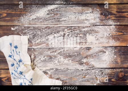 Composition with flour, cookie cutters, eggs and rolling pin on dark ...