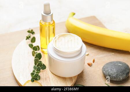 Composition with banana cosmetics on light background Stock Photo - Alamy