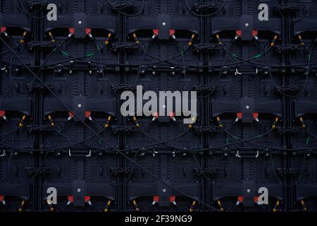 Backside of big LED screen monitor display. Texture of back view of LED panels. Power input and ...