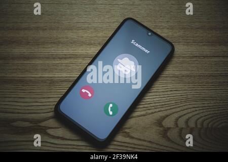 Incoming call from Scammer. Online scam on phone Stock Photo - Alamy