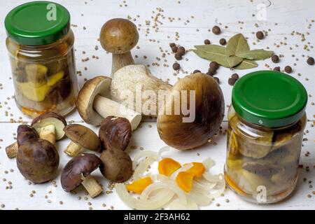 Pickled boletus with spices on a white background Stock Photo - Alamy