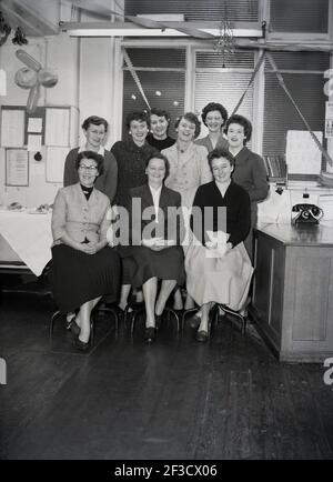 1950s, Historical. A typing pool in a factory. Female secretarial staff ...