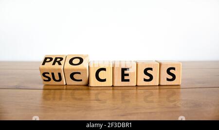 Success process symbol. Turned wooden cubes and changed the word ...