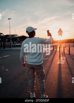 A handsome black Spanish male taking a selfie with his smartphone Stock ...