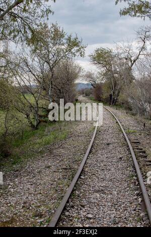 Train tracks running through industrial area on outskirts of small town ...