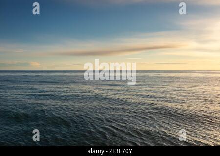 Wavy blue ocean gleaming under the blue sky Stock Photo - Alamy