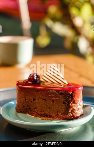 Vertical closeup shot of a piece of delicious summer orange cake with ...