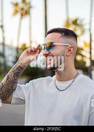 A Spanish cool man with tattoos and sunglasses Stock Photo - Alamy