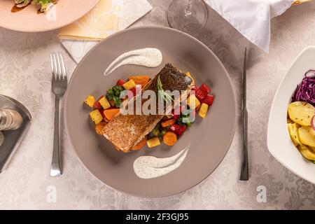 Grilled Salmon Steaks on a Plate with Lemon and Tomato Stock Photo - Alamy