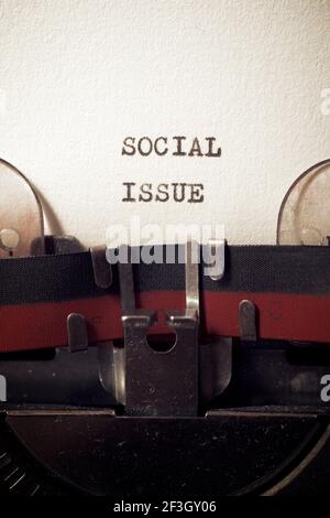Social issue phrase written with a typewriter Stock Photo - Alamy