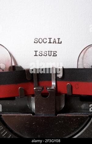 Social issue phrase written with a typewriter Stock Photo - Alamy