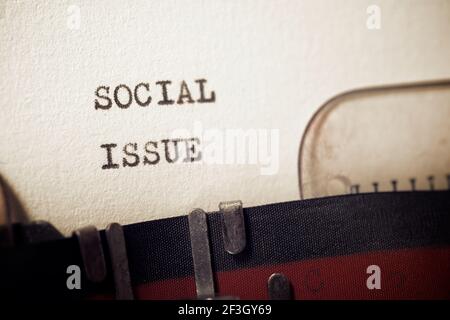 Social issue phrase written with a typewriter Stock Photo - Alamy