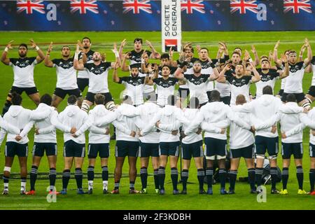 France's players look on as the New Zealand players peform a Haka ...
