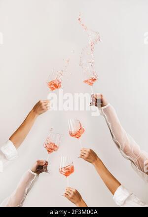 Female hand swirling glass of rose wine making splash Stock Photo - Alamy