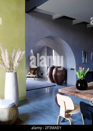 Dining table, vase of pampas grass and wine bottle in room Stock Photo ...