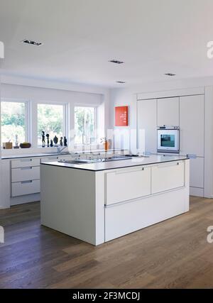 Kitchen island and uncurtained windows in residential home, Denmark ...