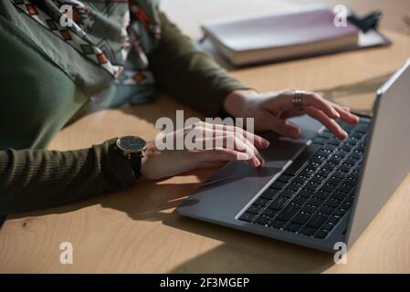 Unrecognizable Muslim businesswoman sitting at table in front of her ...