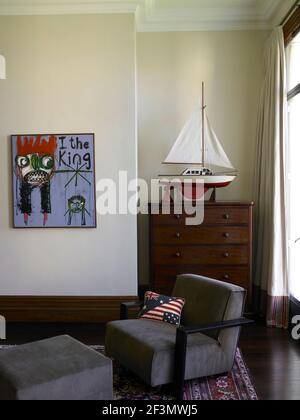 Interior of room with armchair, chest of drawers, folding screen and ...