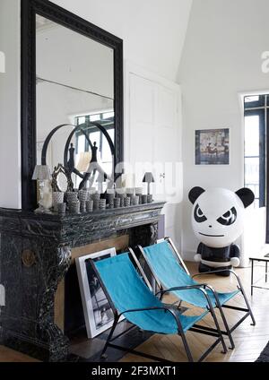 Black and white beakers arranged on fireplace mantelpiece in French ...