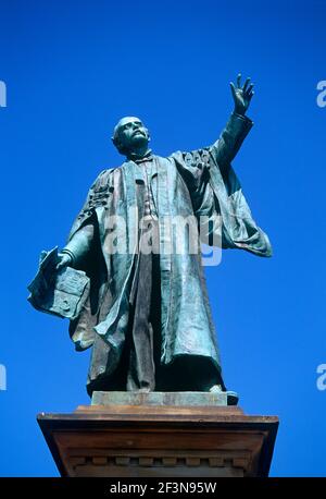 A low angle shot of a statue and tall tree in Paseo Victorica, Tigre ...