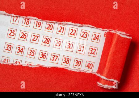 Red paper torn to reveal lottery ticket numbers Stock Photo - Alamy