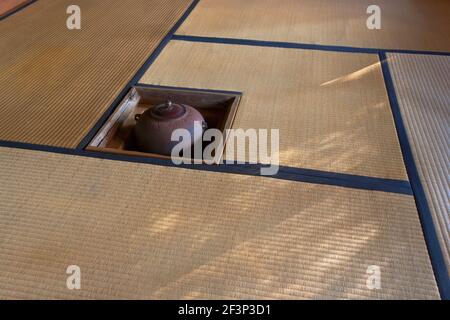 A naturally-lit interior view shows the traditional tatami mat floors ...