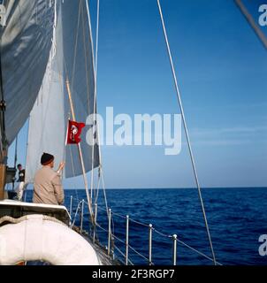 Hoisting sail in a boat Stock Photo - Alamy