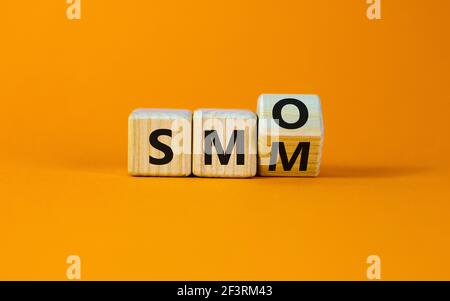 SMM vs SMO symbol. Businessman turns a cube and changes words 'SMM ...