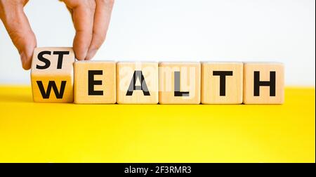 Stealth wealth symbol. Businessman turns the wooden cube and changes ...