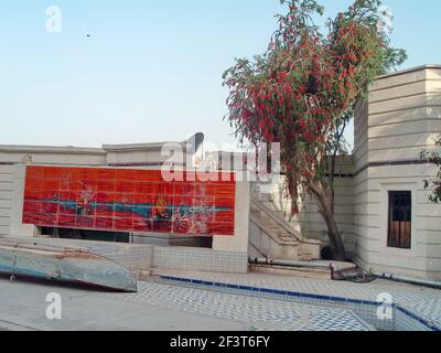 Bottle brush try by a mural on a Sadaam era building on Camp Slayer, in ...