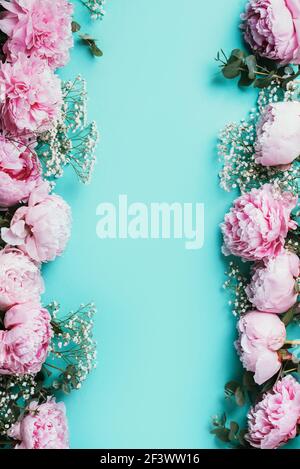 Border frame made of peony flowers on a yellow background. Festive ...