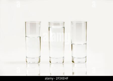 Different water levels in plastic bottles on white background Stock ...